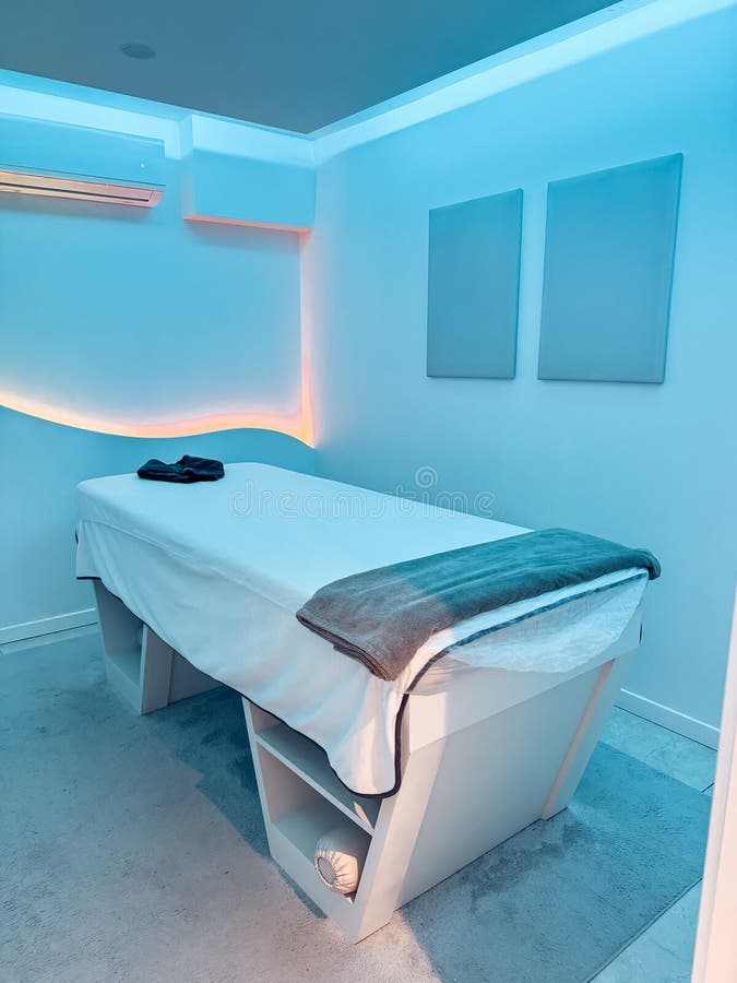 Serene Massage Therapy Room Featuring Calming Blue Hues and Minimalist ...