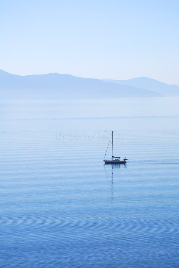 Tranquil Morning Sea with a Sailing Ship Stock Photo - Image of haze ...