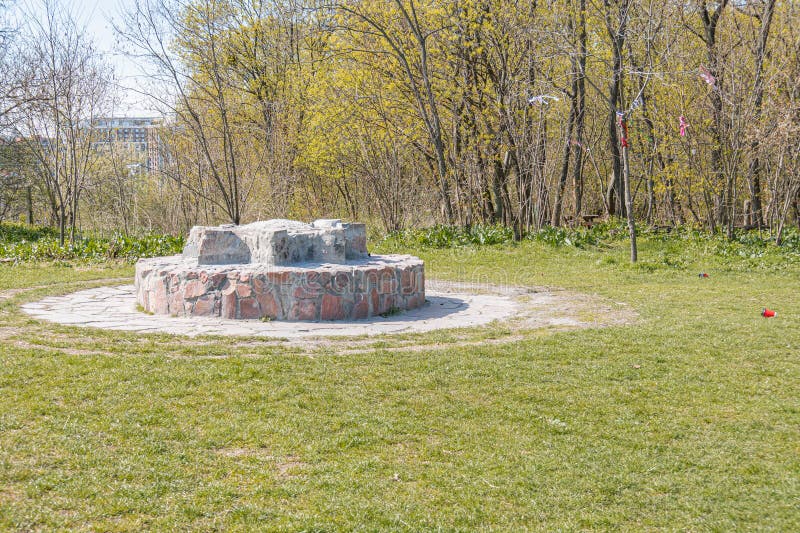 A Tranquil Outdoor Scene Featuring a Circular Stone Structure, Built ...