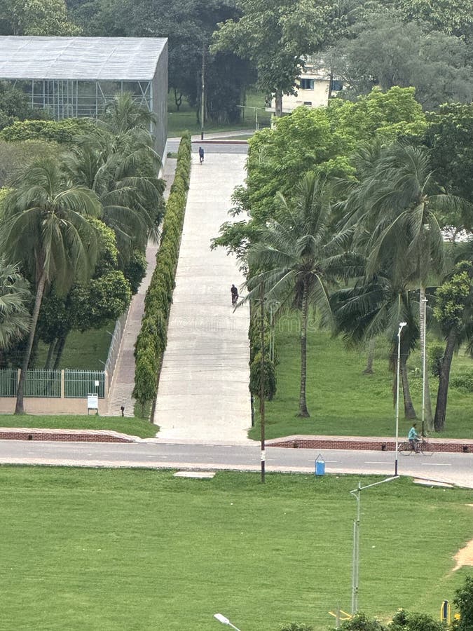 Tranquil Pathway through Lush Urban Park with Cyclists Stock Photo ...