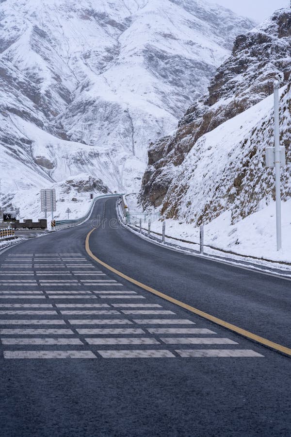Tranquil Scene of an Empty Road in the Foreground, with Rugged Snowy ... Tranquil Scene of an Empty Road in the Foreground, with Rugged Snowy ...