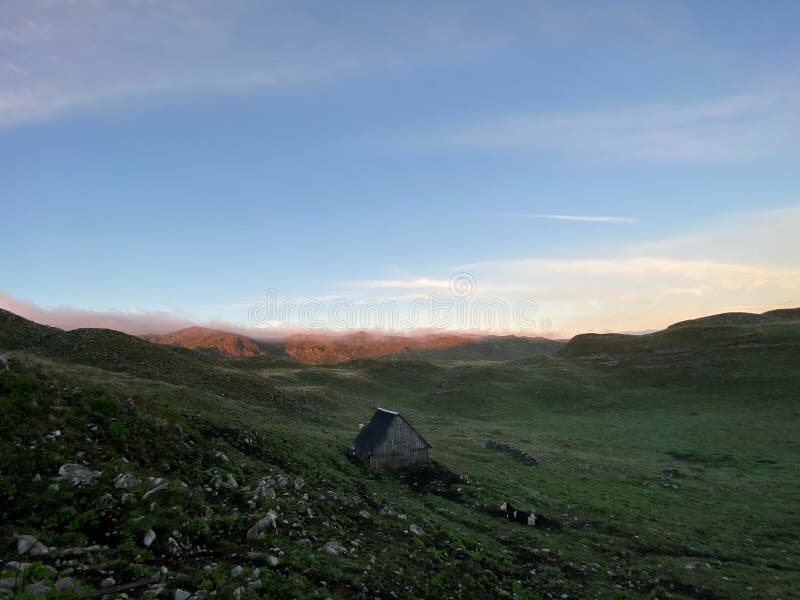 Tranquil Scenery of the Hills with a Single Hut Stock Image - Image of ...