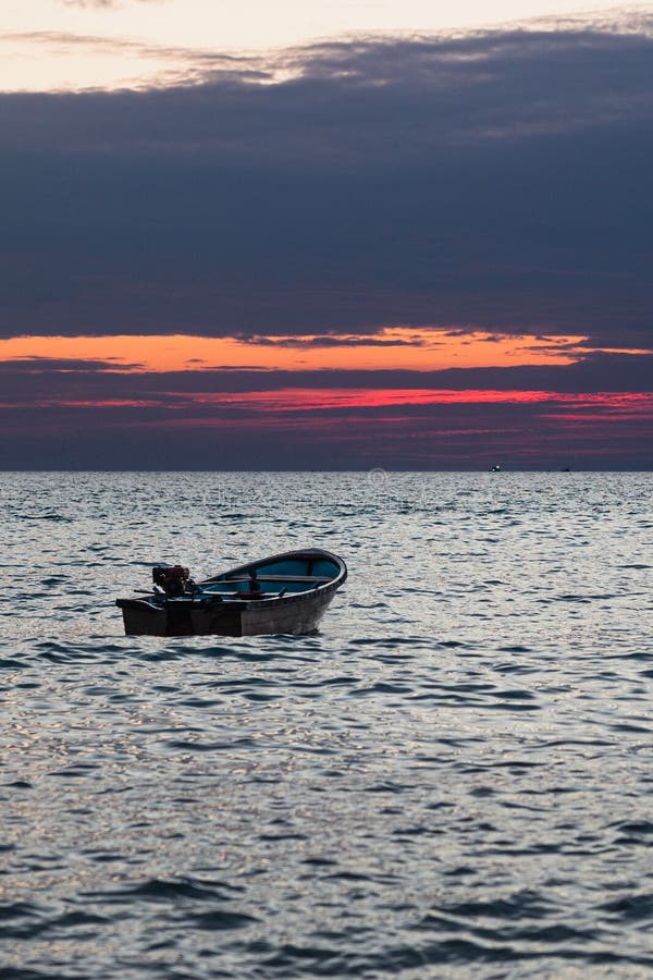 Tranquil Seascape at Sunset, Featuring an Idyllic Sailboat Floating on ...