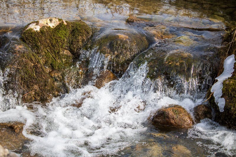 A Stream Flows through Some Large Rocks in the Forest Stream Stock ...