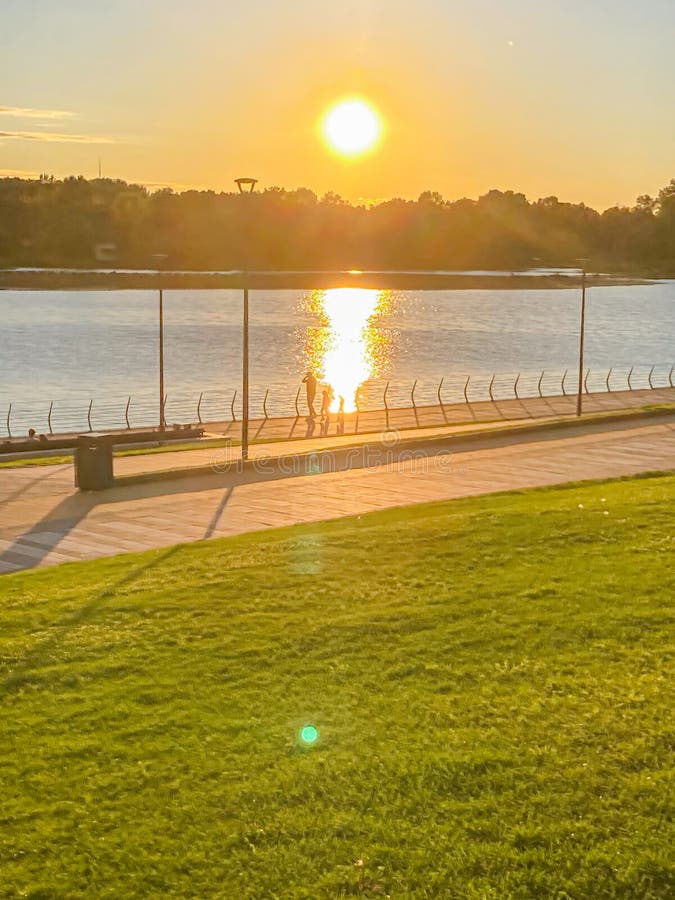 Tranquil Sunset Scene Over a Body of Water, with a Path Leading To the ...
