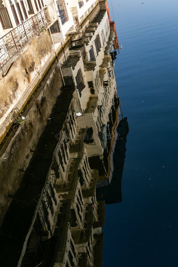 Tranquil Waterfront View of Cityscape with Historic Architecture and ...