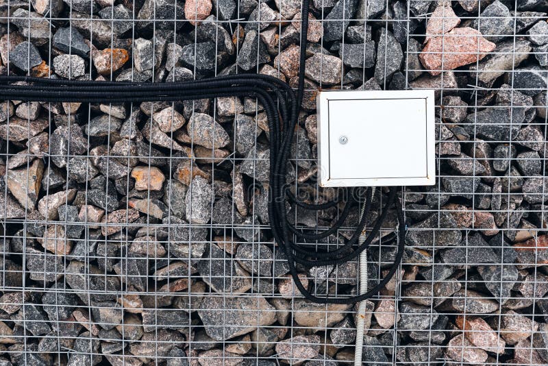 A Transformer Box with Wires Hangs on a Stone Fence. Energy Stock Photo ...