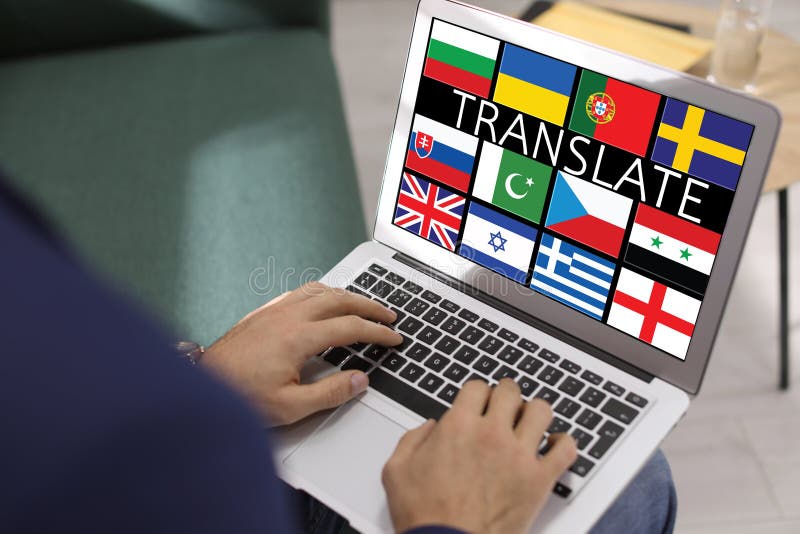 Translator Using Laptop with Images of Different Flags on Screen in ...