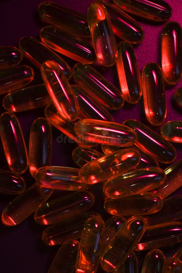 Capsules Under Red Lighting Stock Photo - Image of saturation, orange ...