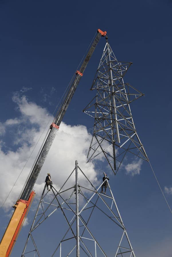 Transmission Tower Assembly with Crane Under Blue Sky. Stock Photo ...