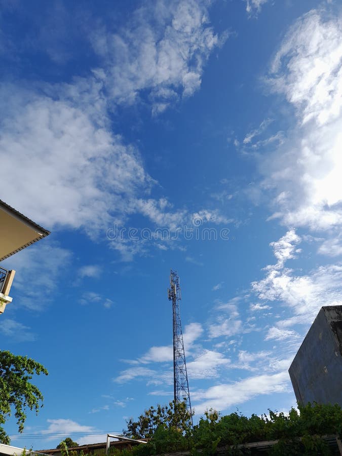 Transmitter Tower with a Background of Blue Sky and Clouds Stock Image ...