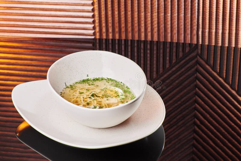 Transparent Beef Broth with Egg, Garnished with Dill in a White Bowl on ...