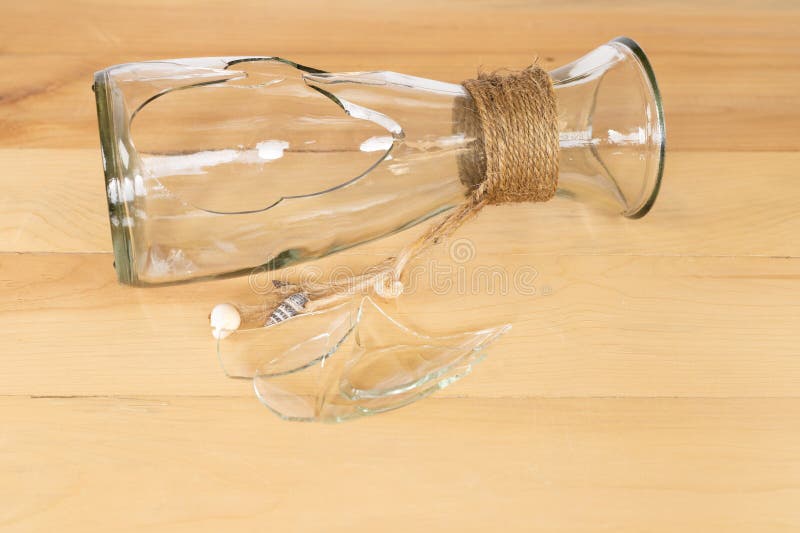 A Transparent Broken Glass Vase with Sharp Edges Laying on a Wooden ...