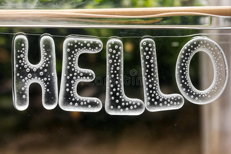 Transparent Bubbly HELLO Sign with Greenery in Background Stock ...