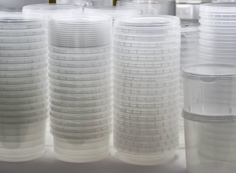 Transparent Containers Arranged in Stacks on a Table in a Well-lit Area ...