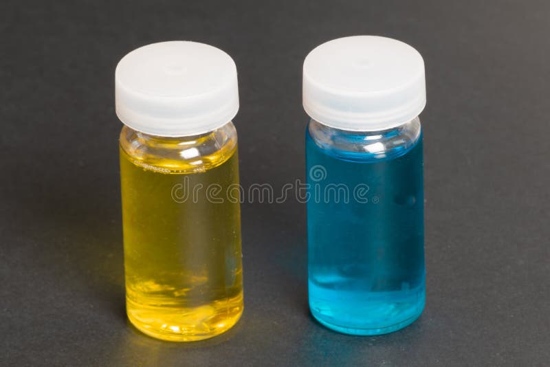 Two Small Transparent Containers with Yellow and Blue Liquid Stock ...