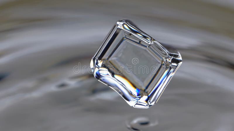 Transparent Crystal with Octagonal Faces Rotates Slowly Above a Rippled ...