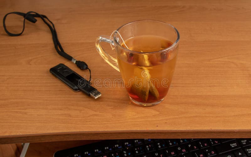A Transparent Cup of Tea on a Working Computer Stock Image - Image of ...