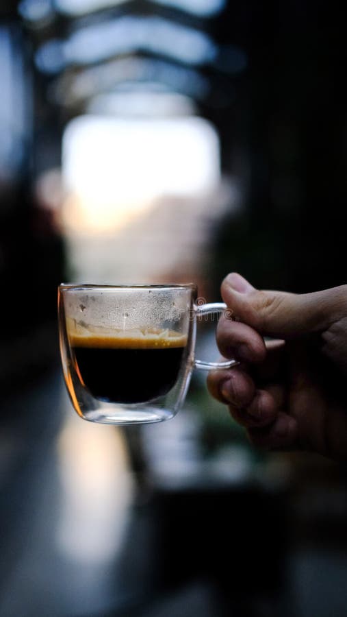 Transparent Glass Cup of Coffee in the Hand. Coffee in a Cafe Stock ...
