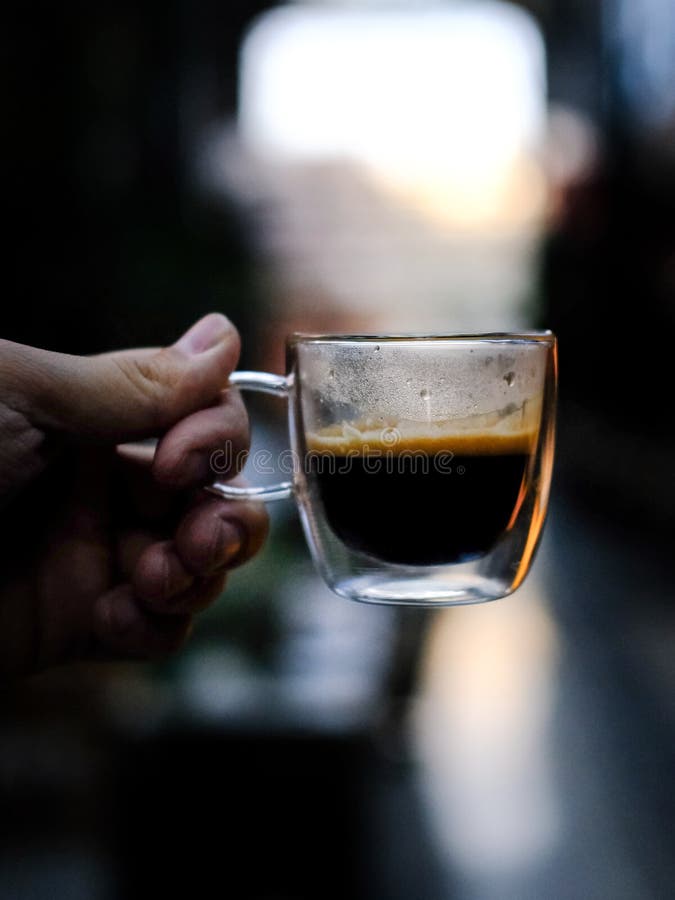 Transparent Glass Cup of Coffee in the Hand. Coffee in a Cafe Stock ...