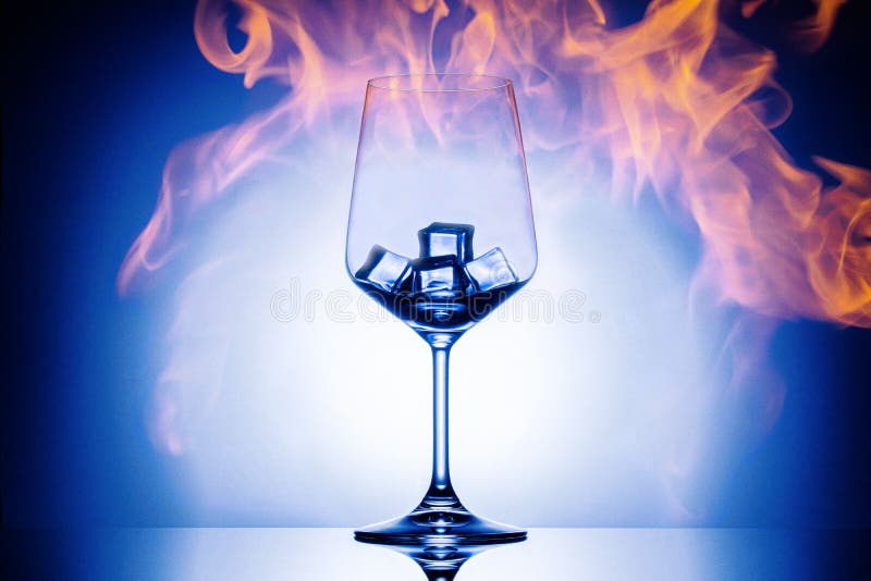 Transparent Glass with the Ice Cubes Surrounded by Fire Flames on a ...