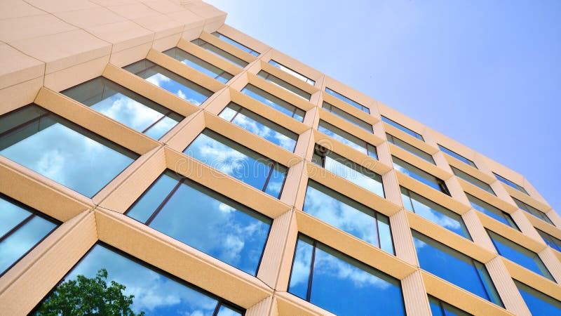 Modern Office Building with Glass Facade on a Clear Sky Background ...
