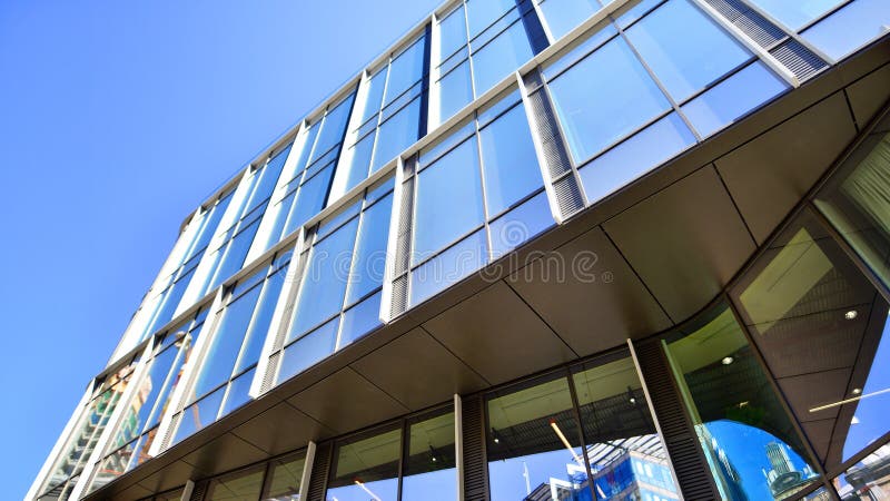 Modern Office Building with Glass Facade on a Clear Sky Background ...
