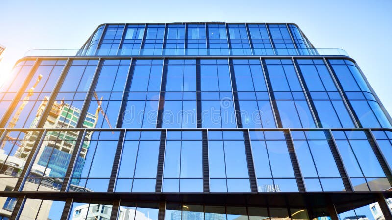 Modern Office Building with Glass Facade on a Clear Sky Background ...