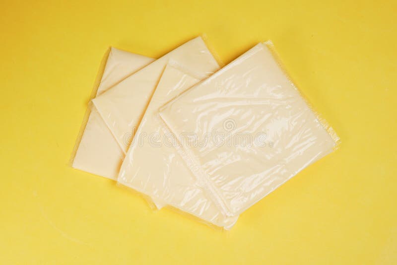 Transparent Packet with Slices of Cheese on Yellow , Stock Photo ...