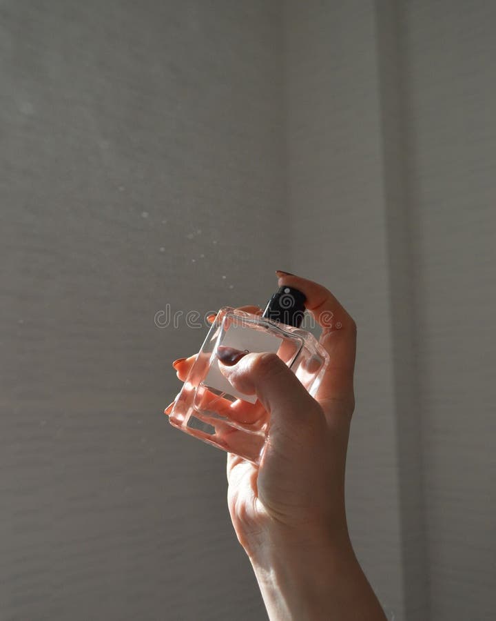 Transparent Perfume Bottle in the Sun. Beautiful Hand Pose Stock Image ...