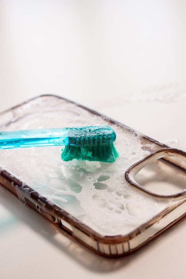 Transparent Phone Case Being Cleaned with a Toothbrush, Showing before ...