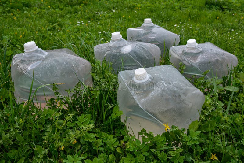 Transparent Plastic Cube for Water Storage , on Green Grass Stock Photo ...
