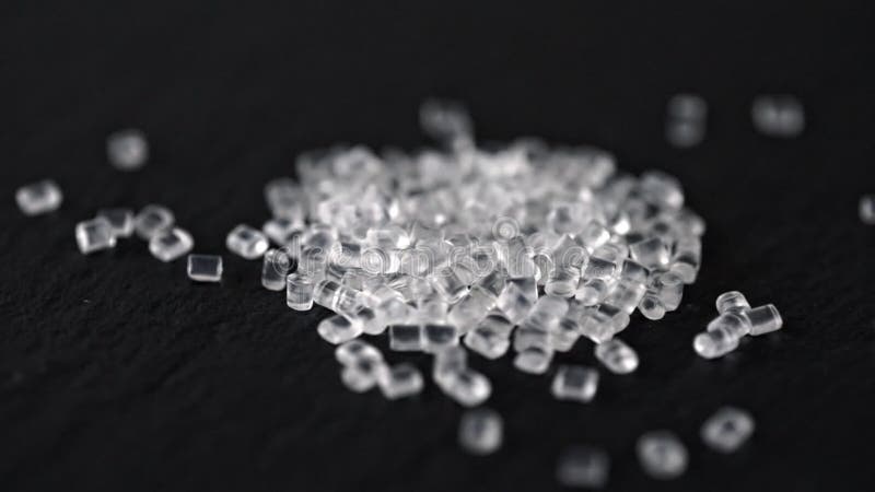 Transparent Plastic Granules are Pouring Down on a Black Background ...