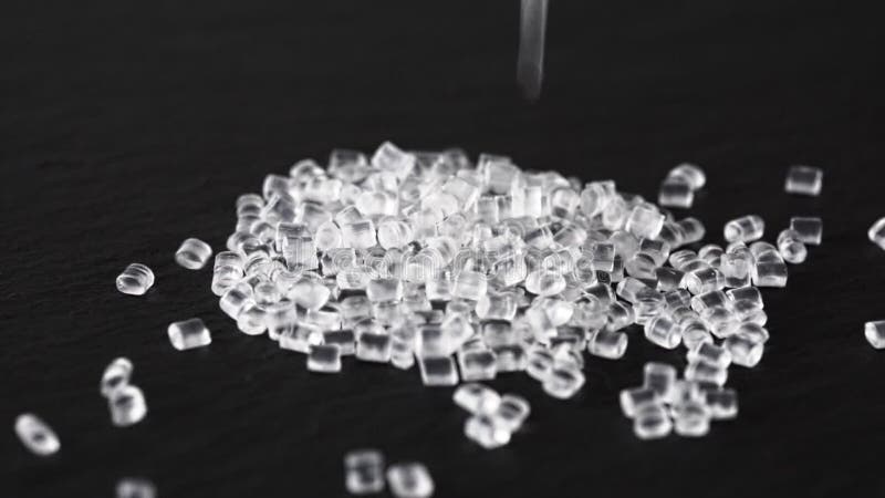 Transparent Plastic Granules are Pouring Down on a Black Background ...