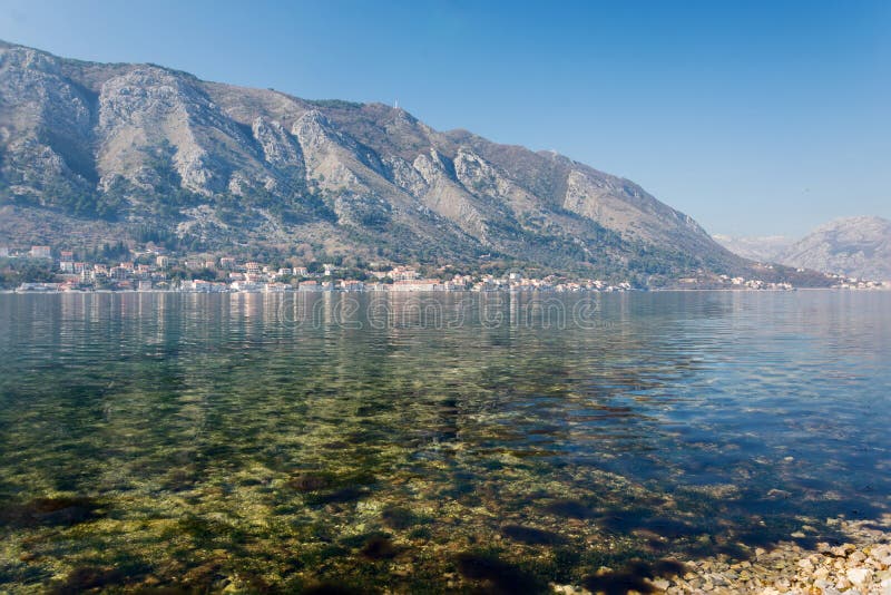 Transparent Sea with Mountains in the Background Stock Image - Image of ...