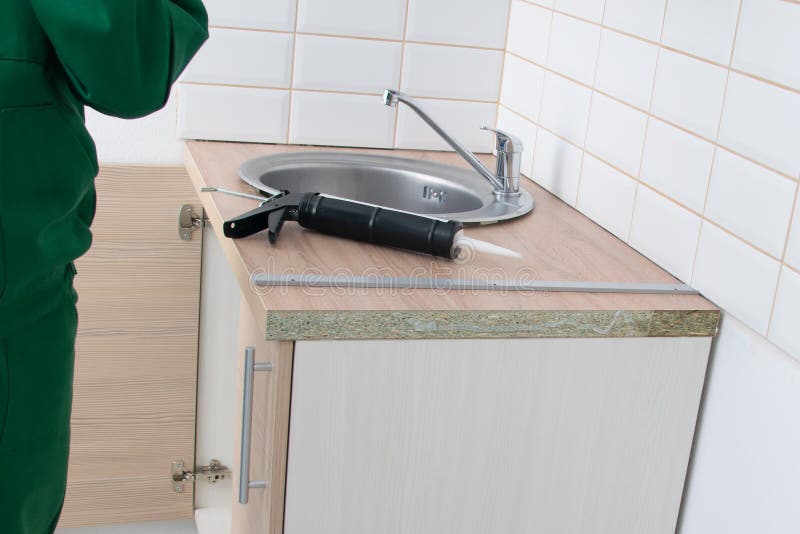 Transparent Silicone is Applied To the Edge of the Kitchen Countertop ...