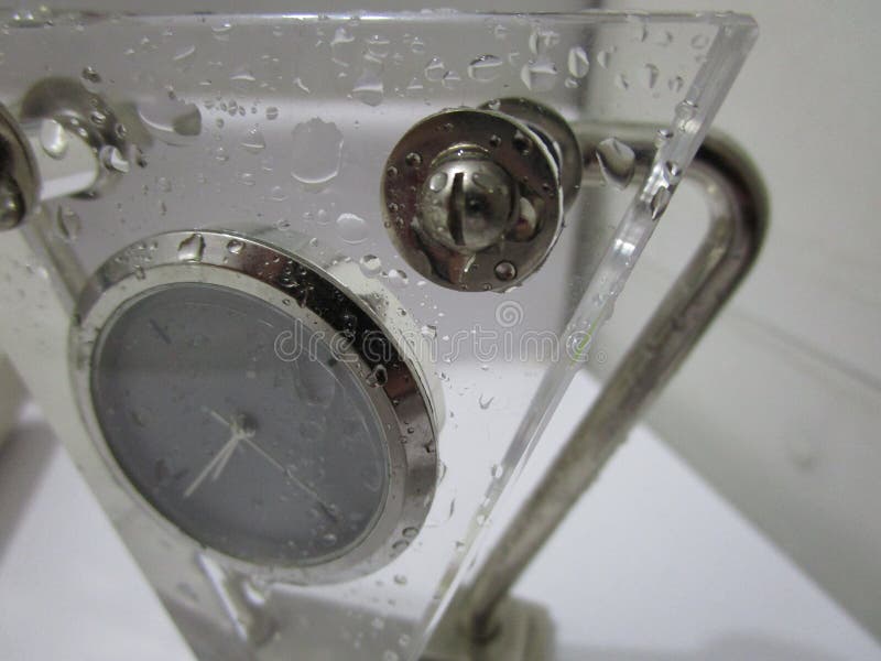 Triangular Prism Desk Clock Wet with Water Droplets. Stock Photo ...
