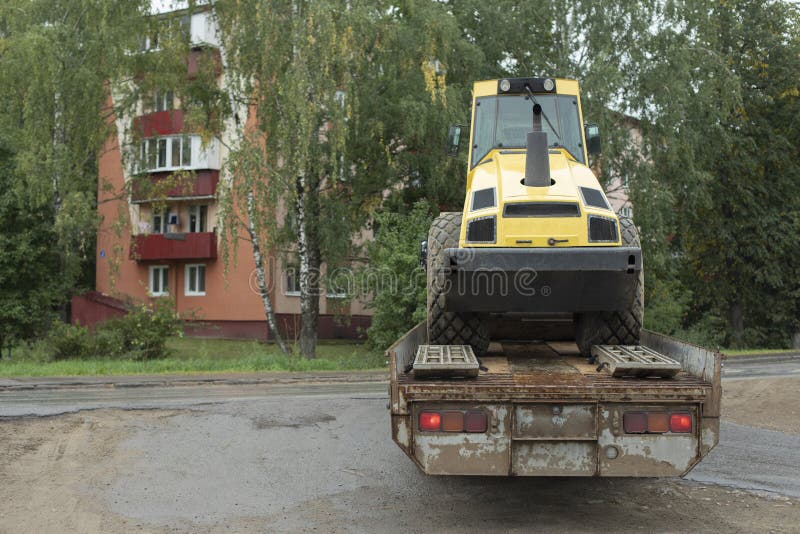 Transportation on Platform of Heavy Machinery. Yellow Tractor Stock ...