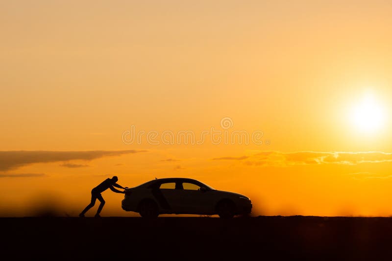 Silhouette of Man Driver Pushing His Car Along on Empty Road after ... Silhouette of Man Driver Pushing His Car Along on Empty Road after ...