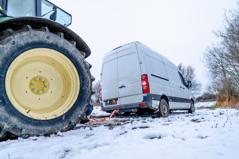 A Transporter Car is Stuck in the Snow and Getting Pulled Out with a ...