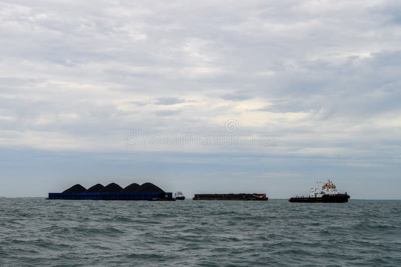 Transporting Coal into Large Ships in the Middle of the Sea Stock Photo ...