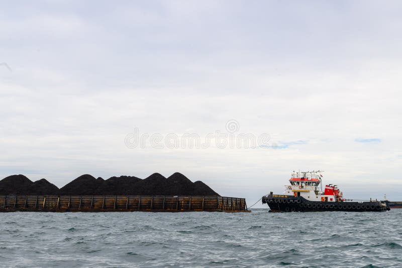 Transporting Coal into Large Ships in the Middle of the Sea Stock Photo ...