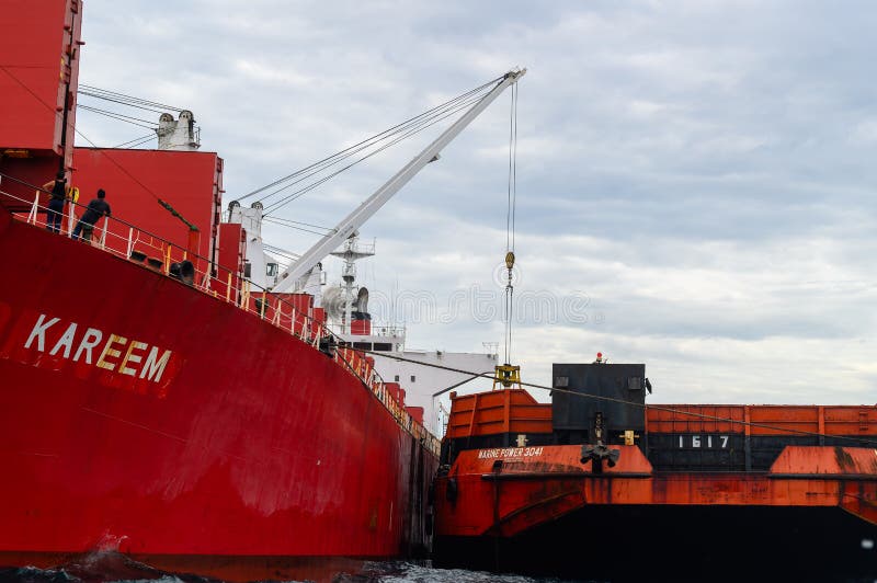Transporting Coal into Large Ships in the Middle of the Sea Stock Photo ...