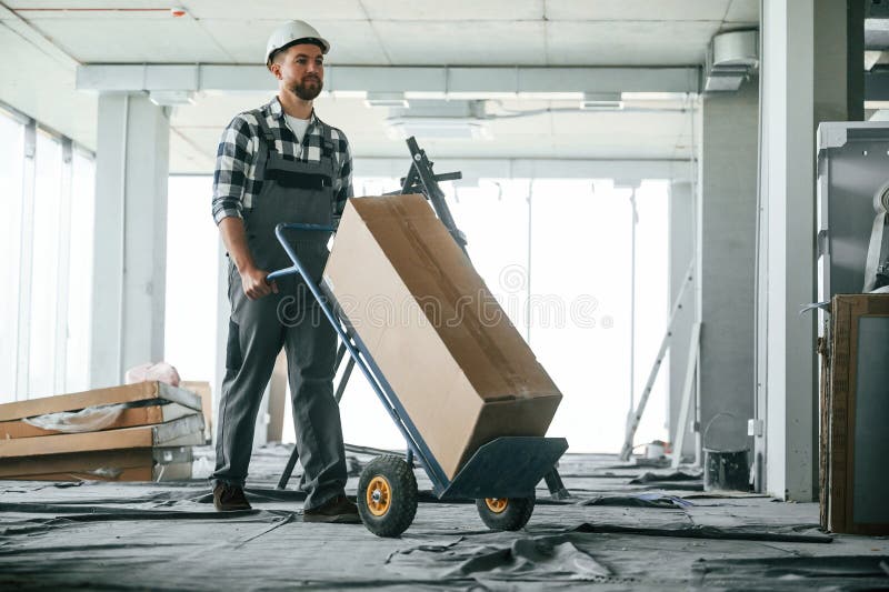 Transporting Long Paper Box. Construction Worker in Uniform in Empty ...