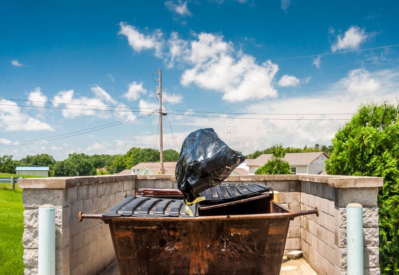 Trash Bag Being Thrown in the Air into a Dumpster Stock Image - Image ...