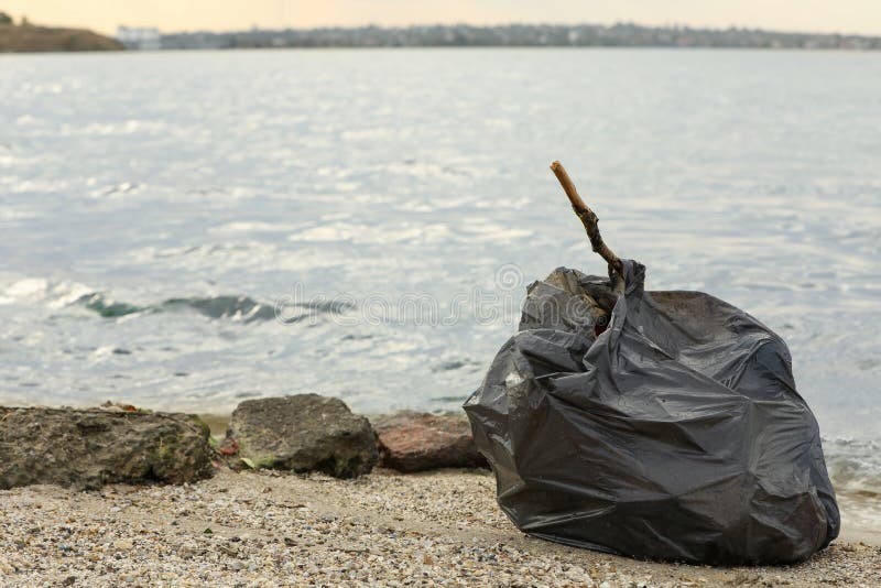 Trash Bag Full of Garbage on Beach. Space for Text Stock Image - Image ...