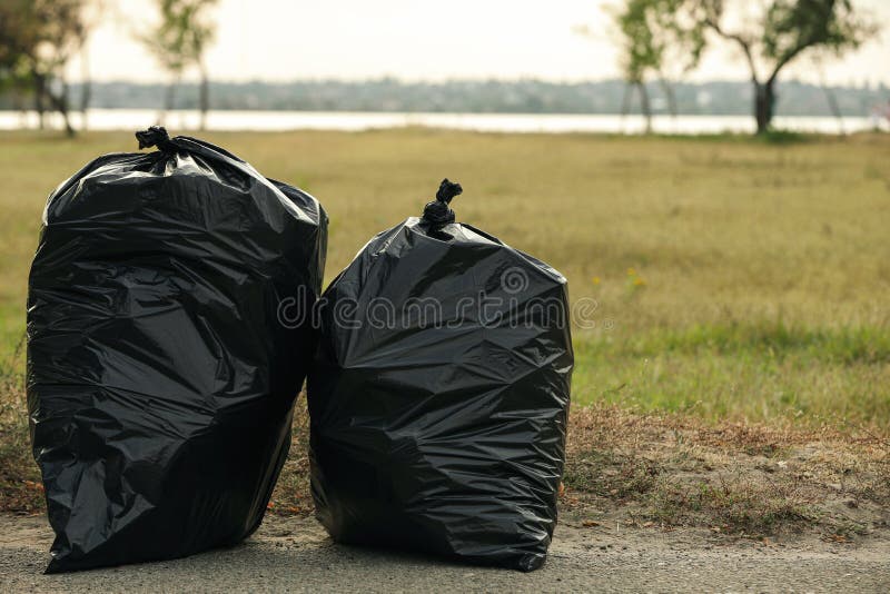 Trash Bags Full of Garbage on Pavement Outdoors Stock Image - Image of ...