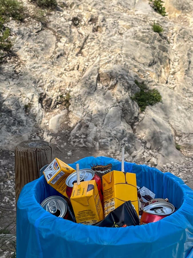 Trash Bin Filled with Assorted Waste Including Cans and Cartons ...