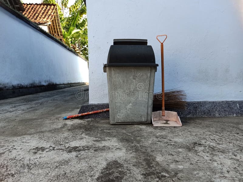 Trash Box and Broom Leaning Against the Wall Stock Image - Image of ...