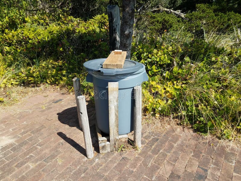 Trash Can with Bricks and Green Plants with Wood Posts Stock Image ...